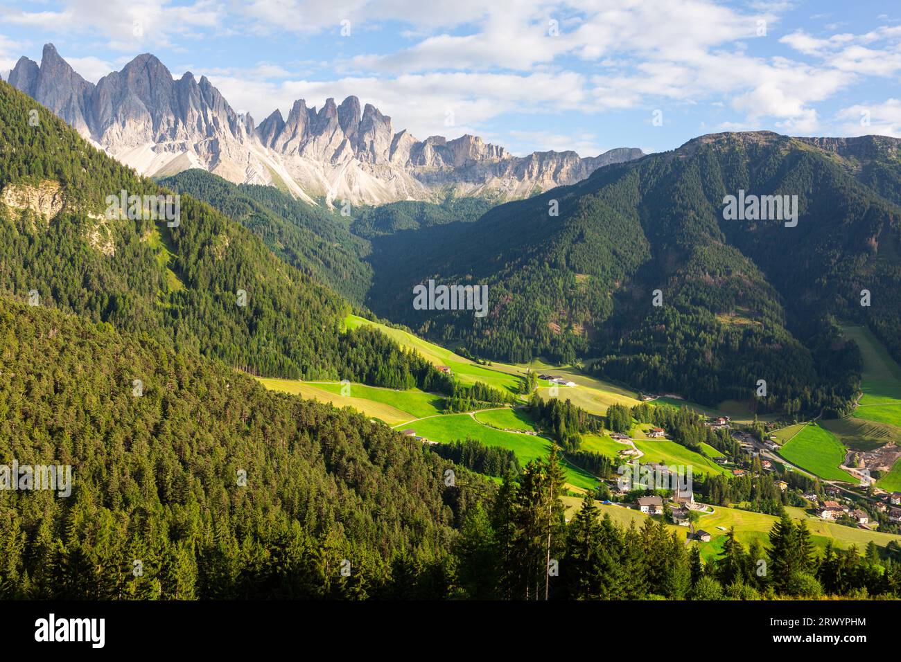Green valley of Val di Funes with rustic cottages against backdrop of ...