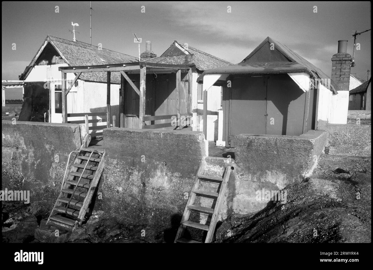 Chalets at Shelly Beach, Exmouth, Devon, England, UK. Greyscale image ...