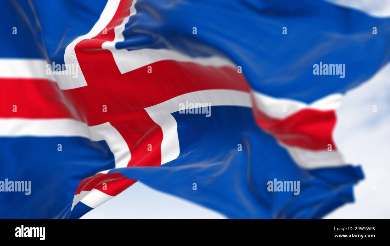 Close-up of Iceland national flag waving. Blue with a white cross and a ...