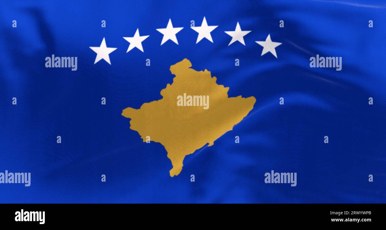 Close-up of Kosovo national flag waving. Six white stars above a golden ...