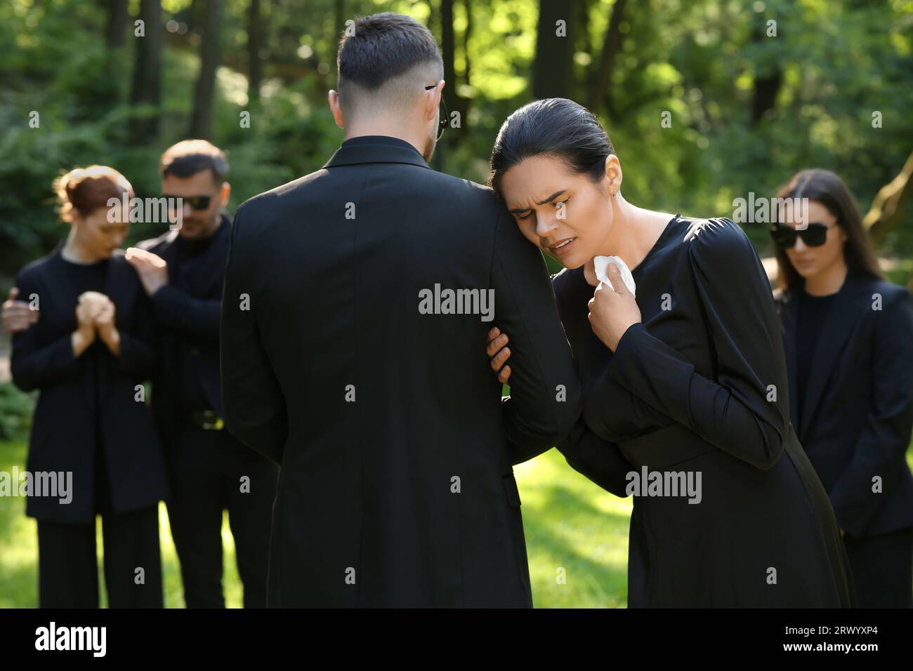 Sad people in black clothes mourning outdoors. Funeral ceremony Stock ...