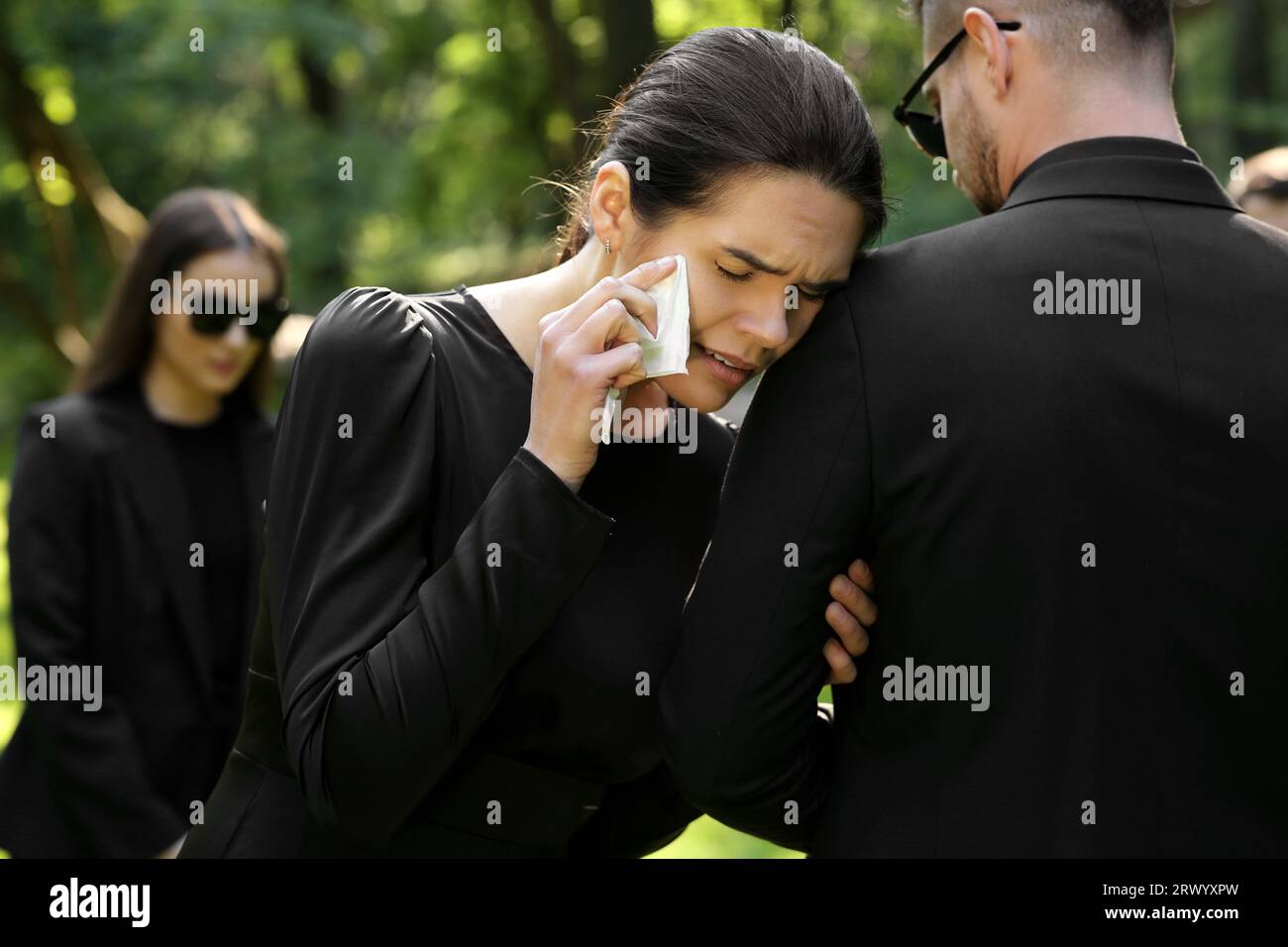 Sad people in black clothes mourning outdoors. Funeral ceremony Stock ...