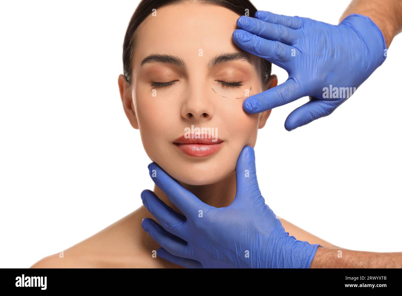 Doctor checking patient's face before cosmetic surgery operation on ...