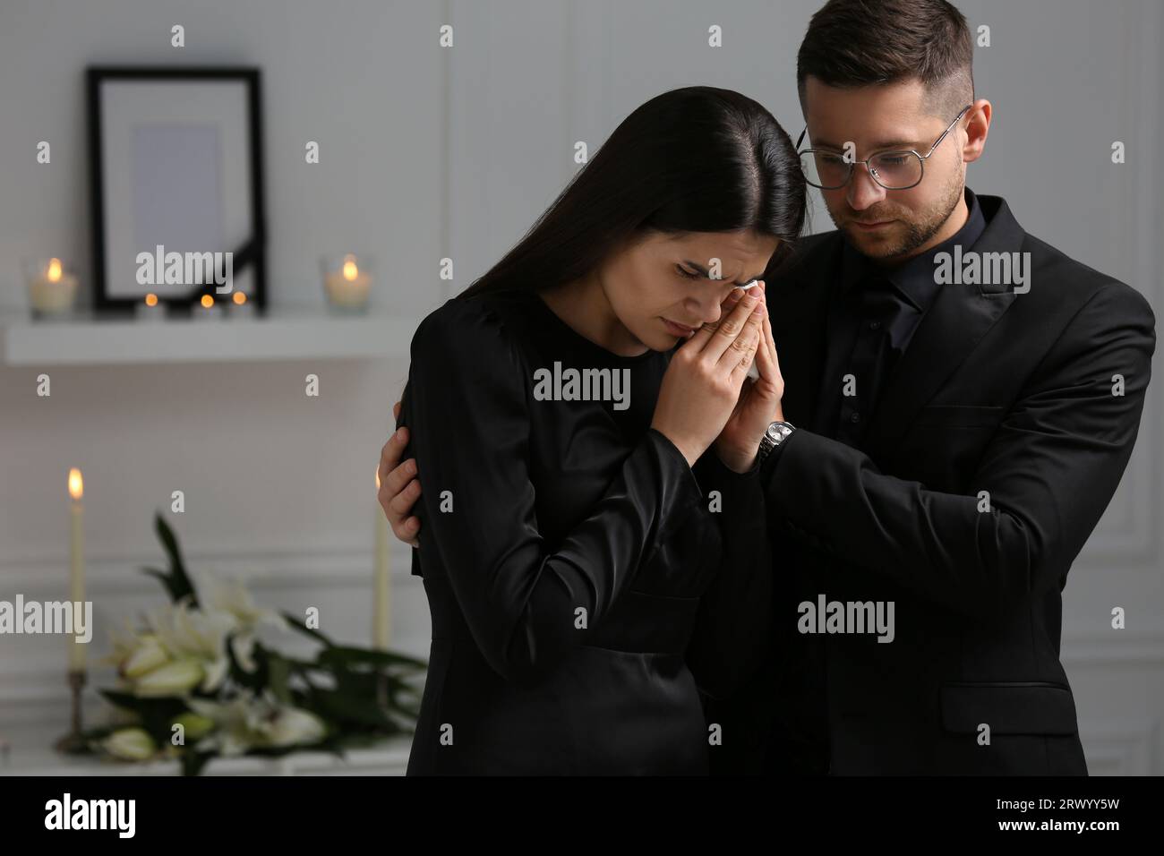 Sad couple mourning in room. Funeral ceremony Stock Photo - Alamy