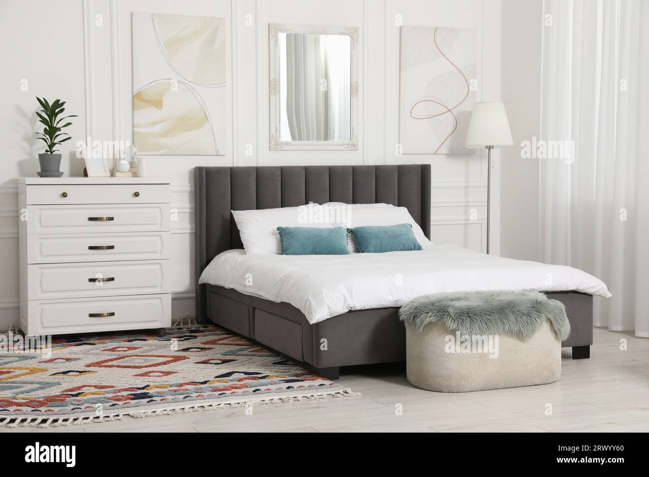 Large comfortable bed in stylish bedroom. Interior design Stock Photo ...