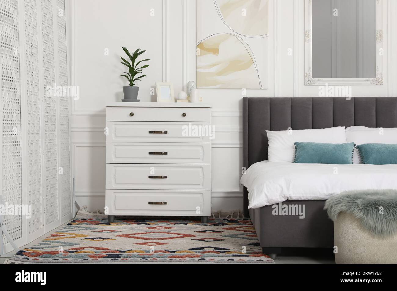 Large comfortable bed in stylish bedroom. Interior design Stock Photo ...