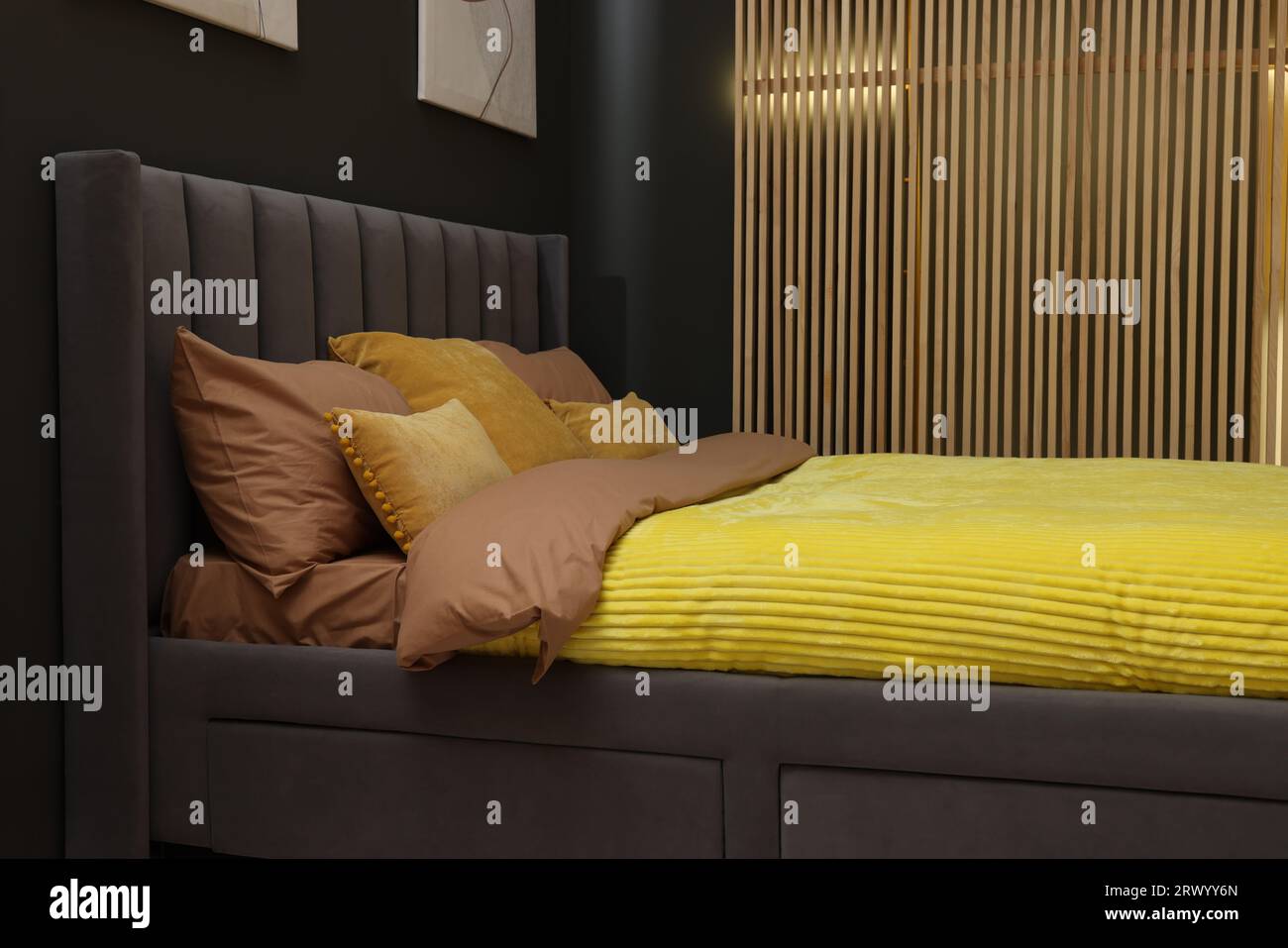 Large comfortable bed in stylish room. Bedroom interior Stock Photo - Alamy