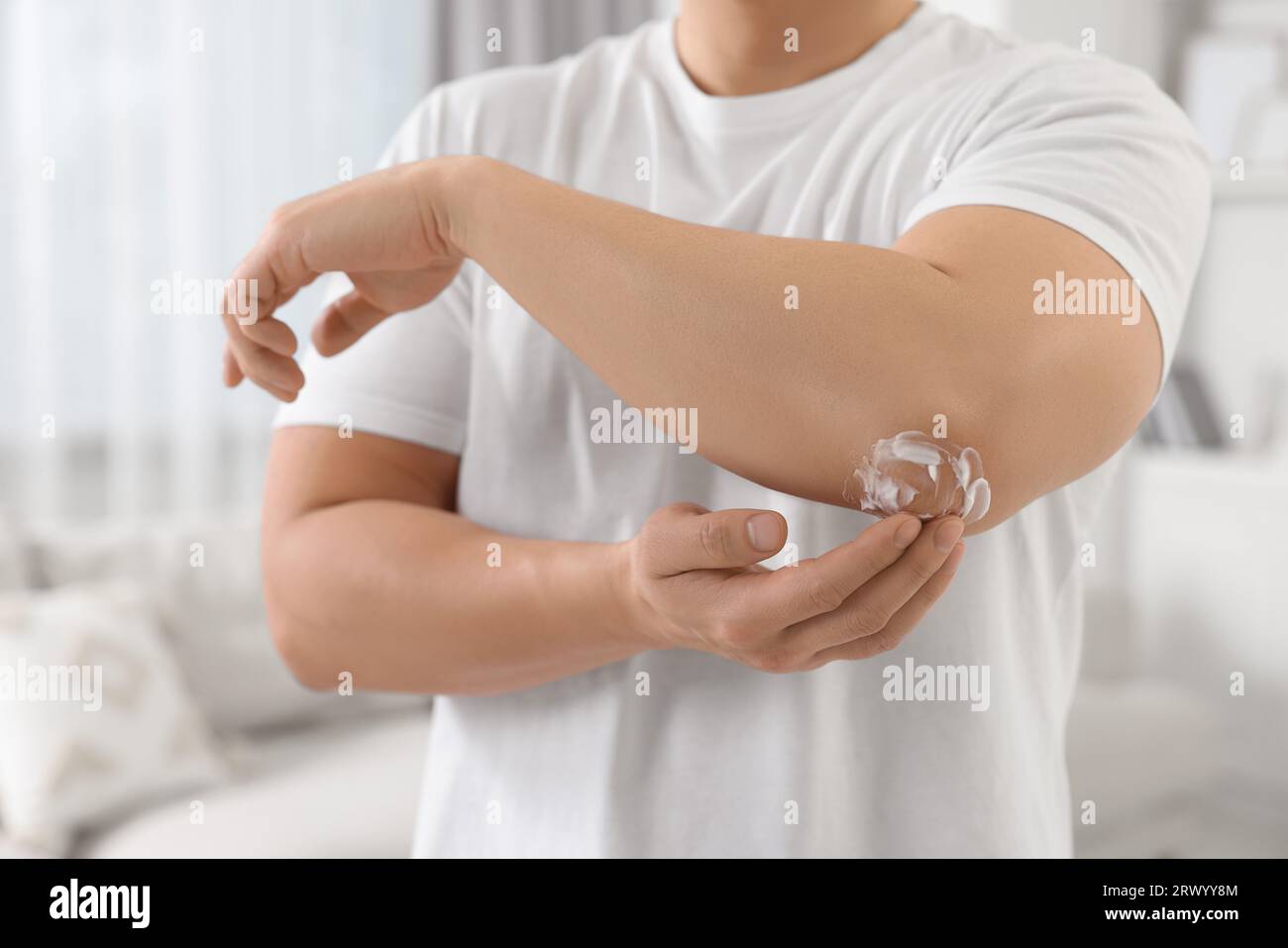 Applying body lotion to her elbow hi-res stock photography and images ...