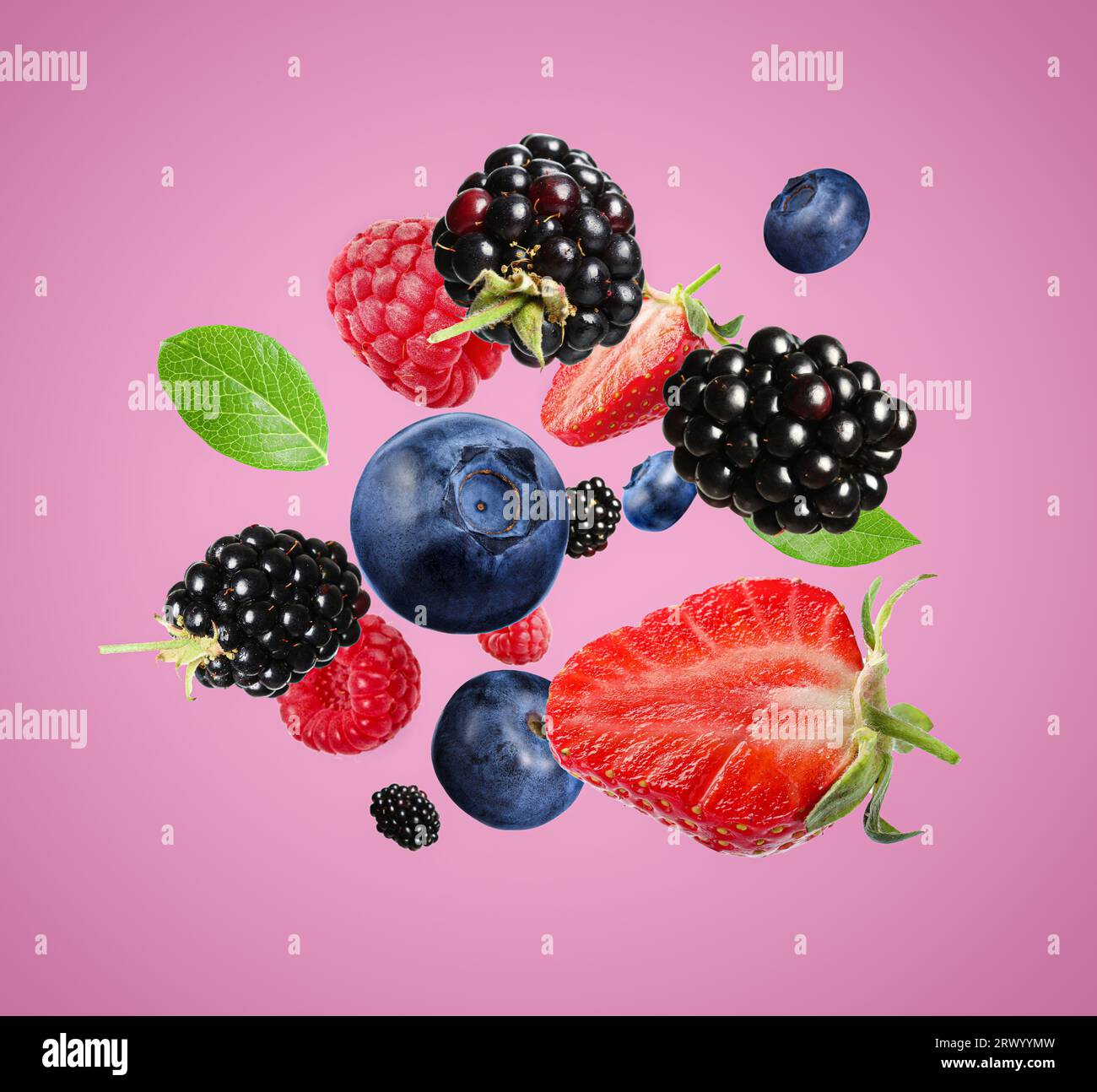 Many different fresh berries falling on hot pink background Stock Photo ...