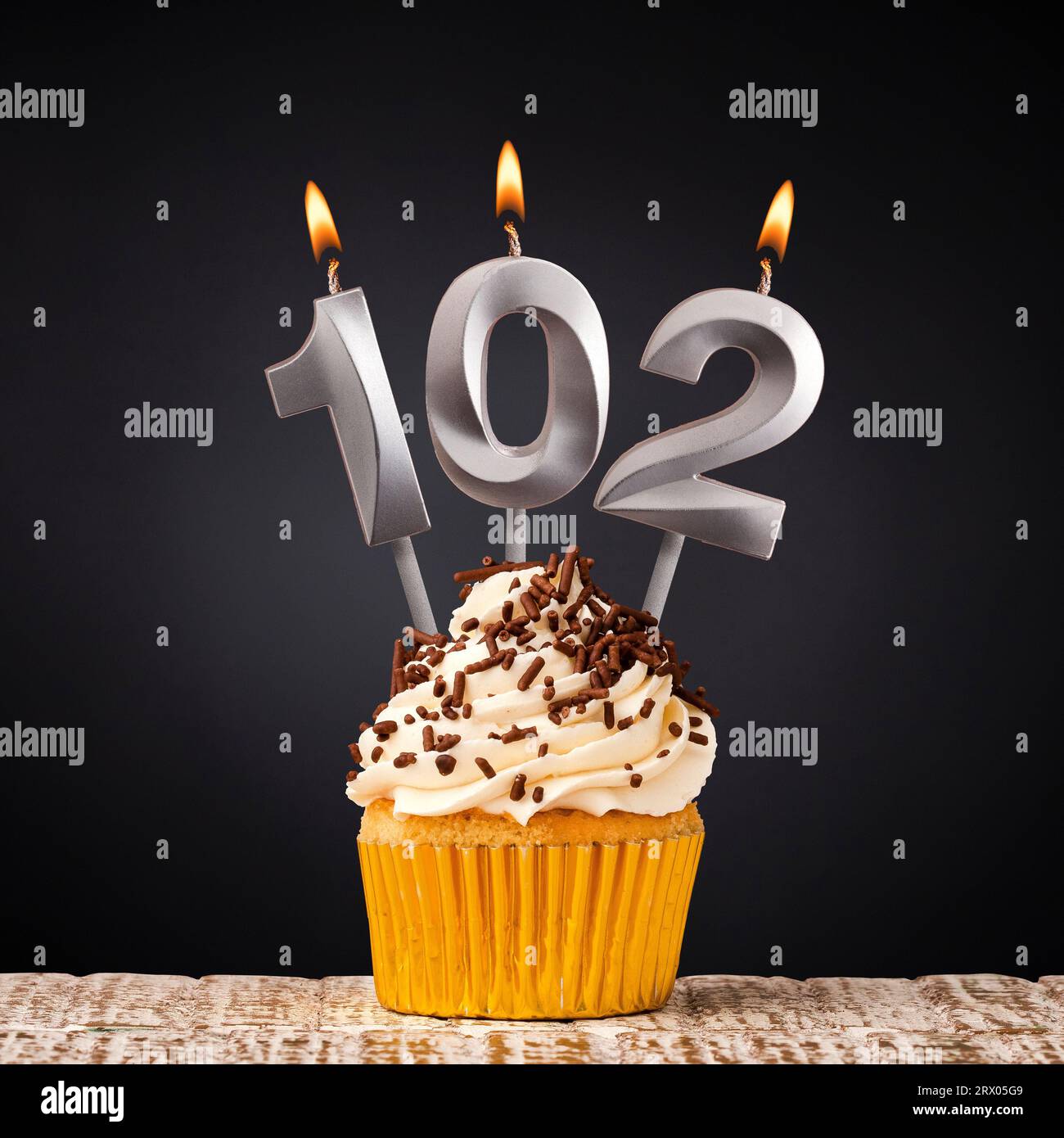birthday cupcake with number 102 candle - Celebration on dark ...