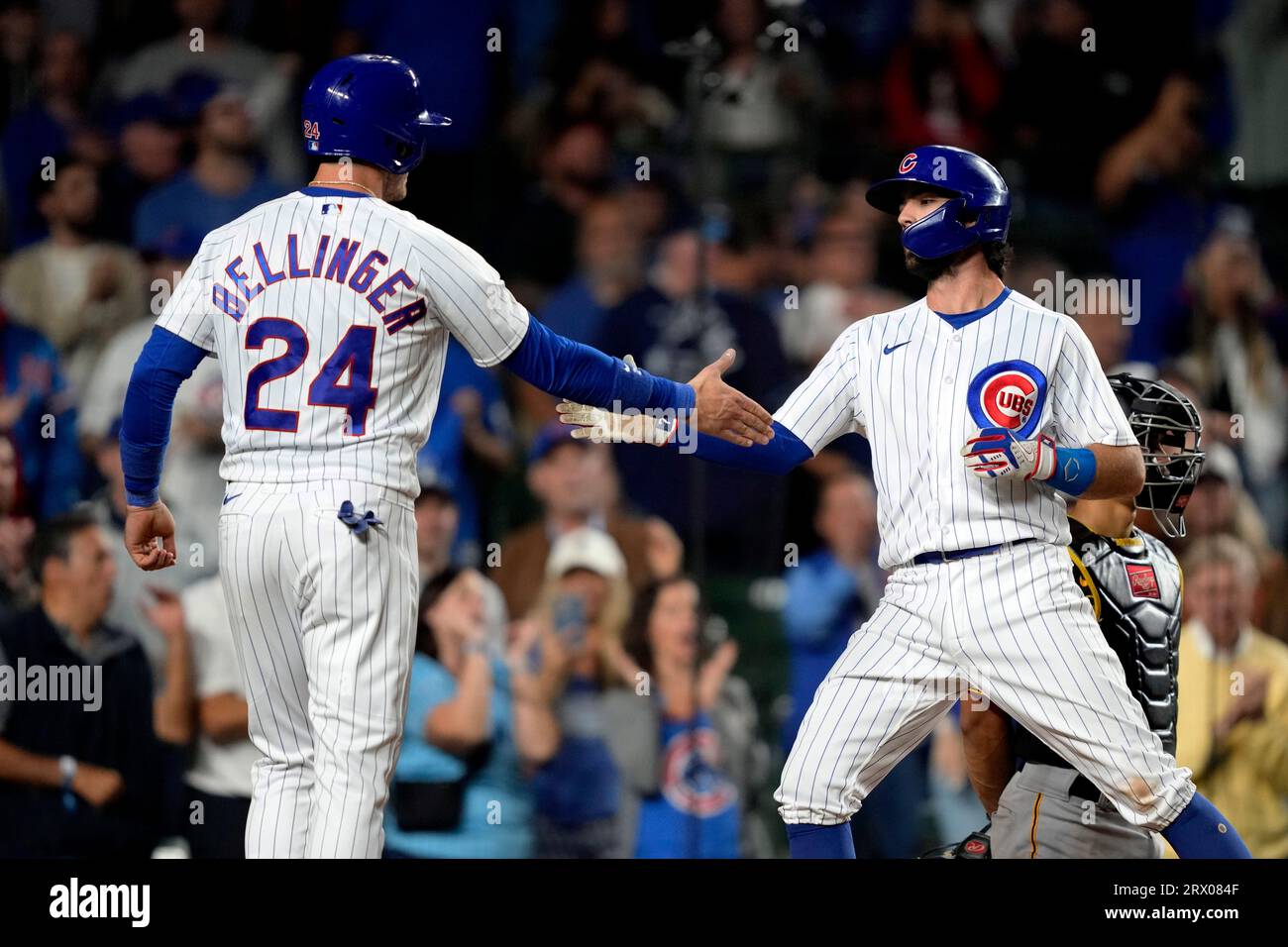 Chicago Cubs' Cody Bellinger (24) greets Dansby Swanson at home after ...