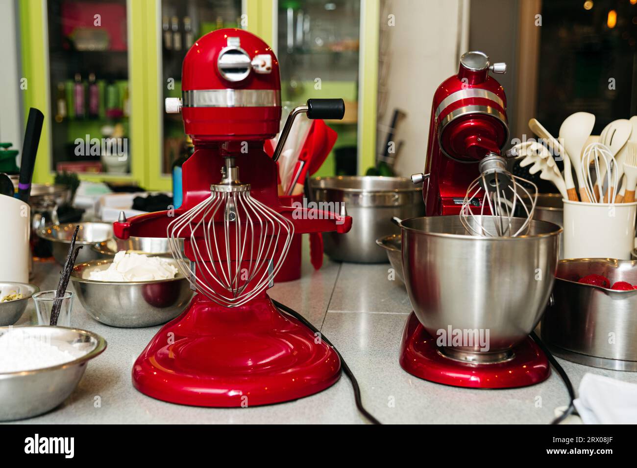 Red kitchen mixer on the counter top. Kitchen utensils and tools ...