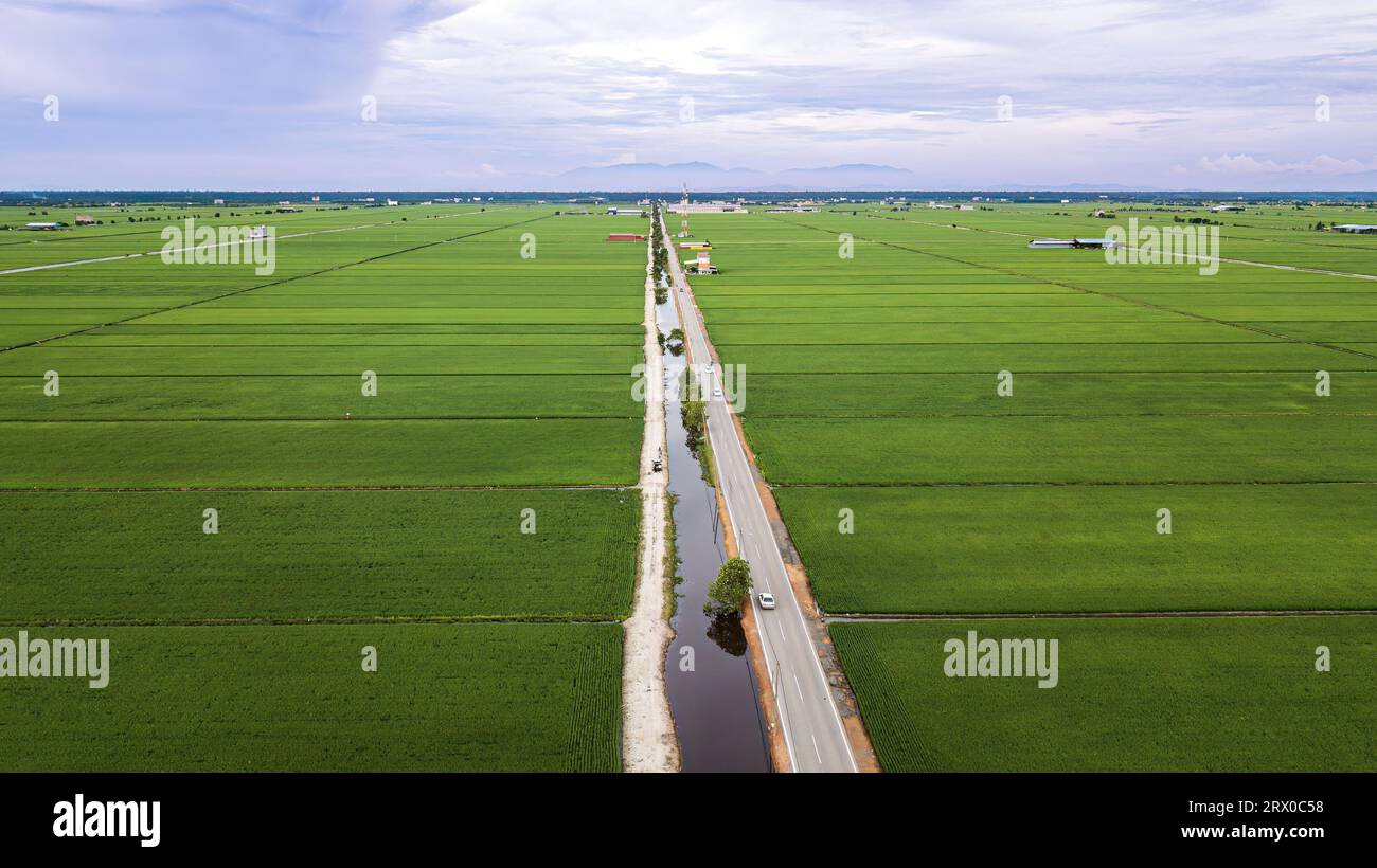 An aerial view of a highway with cars driving through a vast expanse of green grassland Stock ...