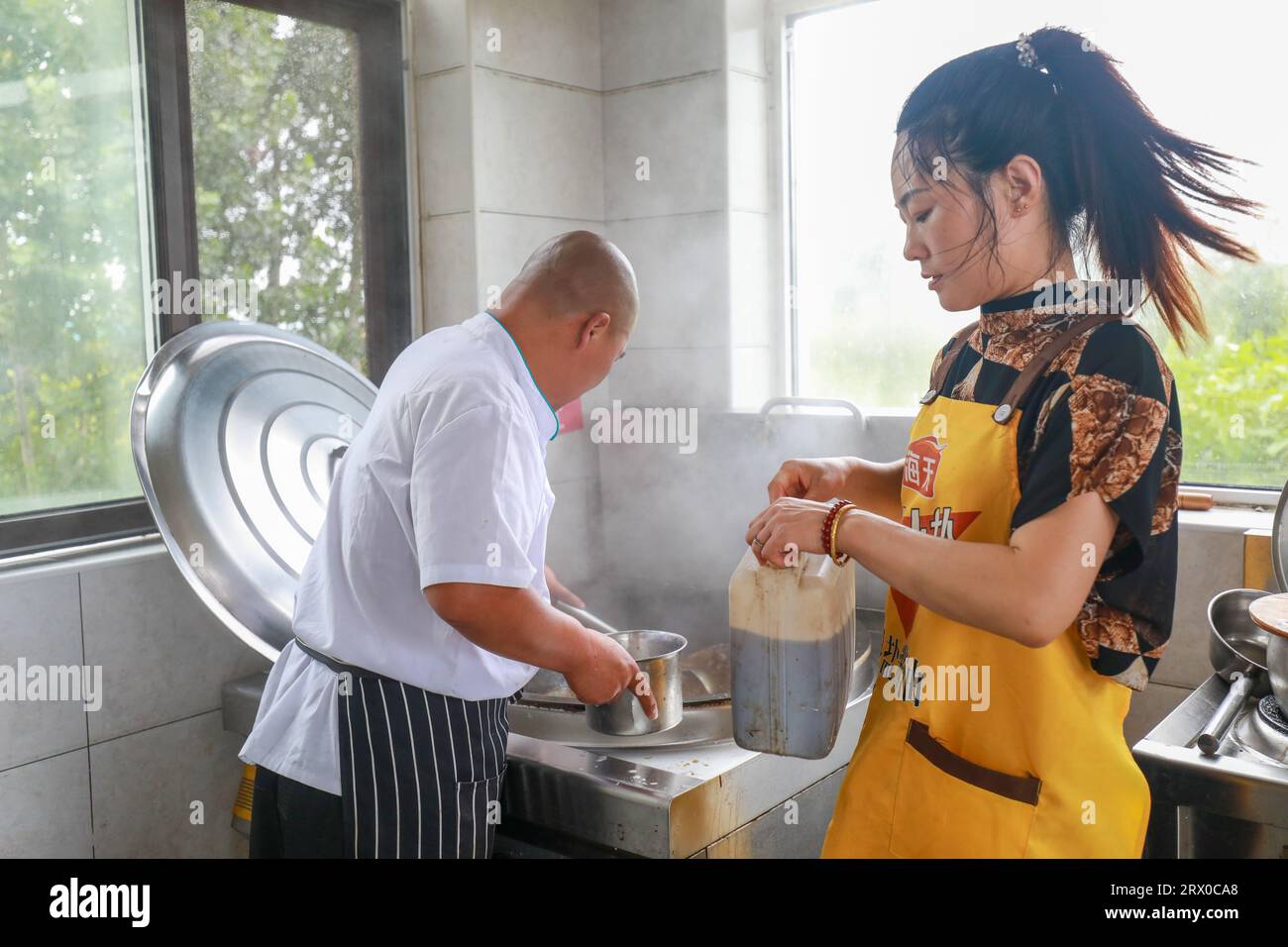 Luannan County, China - August 9, 2023: The cooks are cooking in a ...