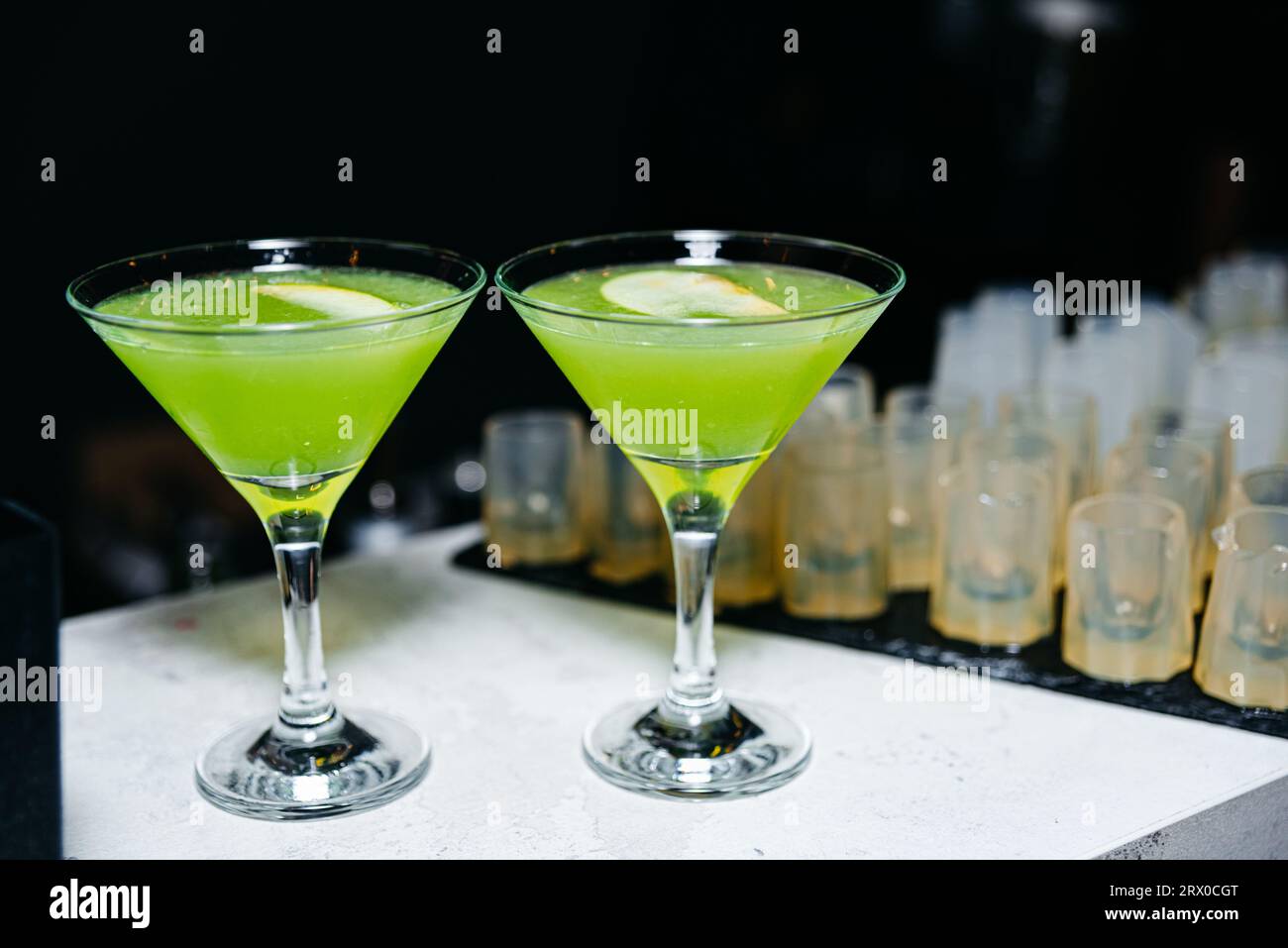 Green cocktail in a martini glass on a bar counter in a nightclub Stock ...