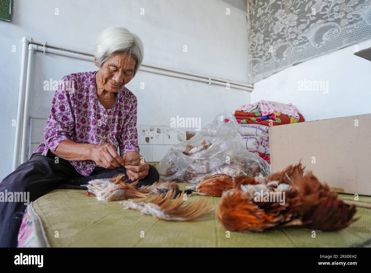 Luannan County, China - August 24, 2022: A rural woman is making a ...