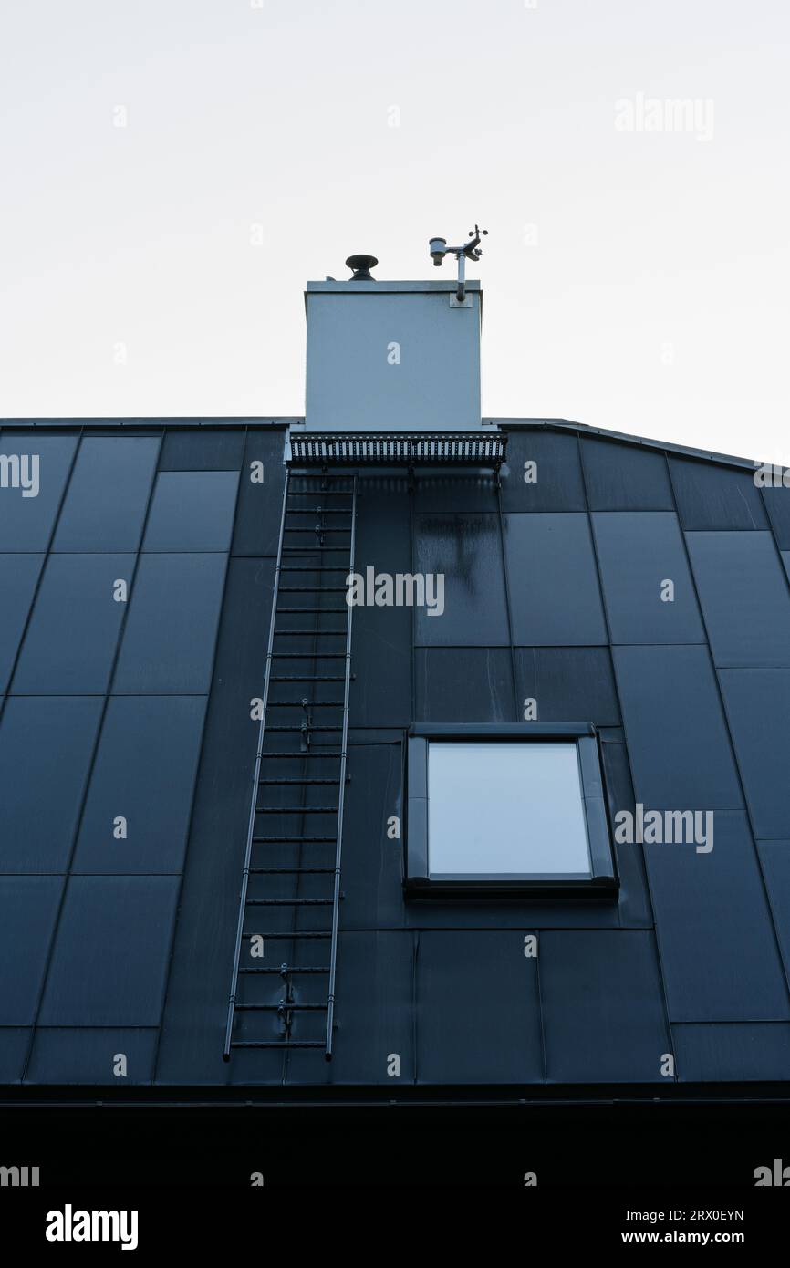 A low-angle of a tall, black building against a clear sky Stock Photo ...
