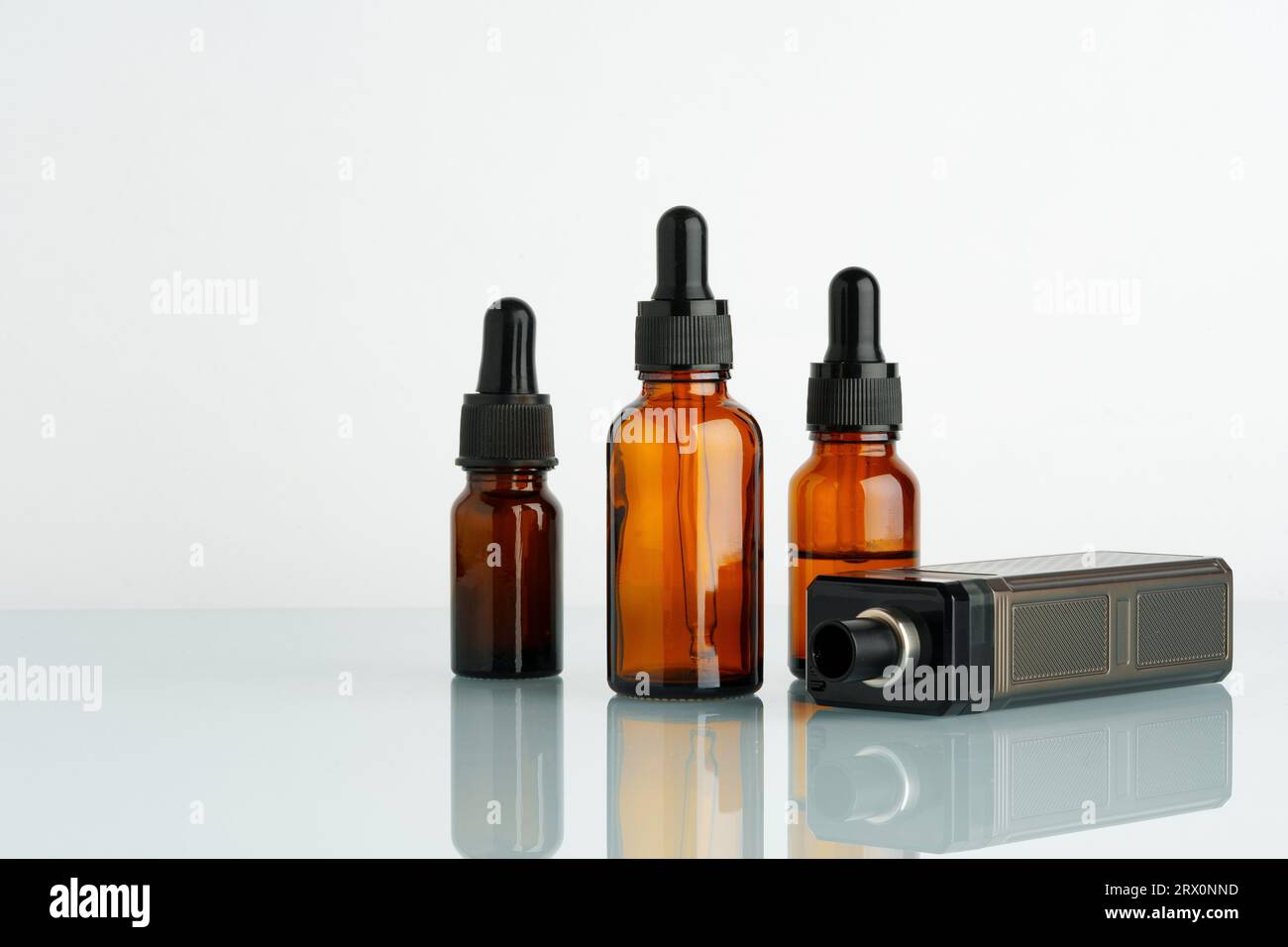 Electronic cigarette with smoking liquid bottle on white background ...