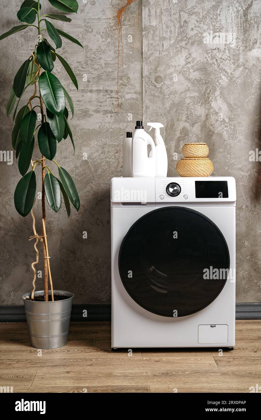 Washing machine in a gray modern laundry room Stock Photo - Alamy