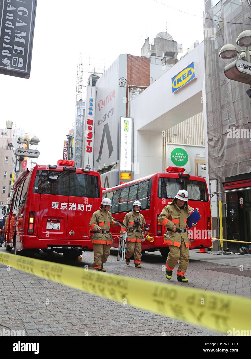 Firefighters inspect the area of fire at Center Gai near Shibuya ...