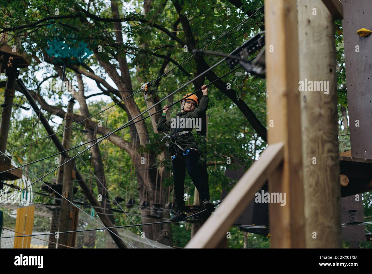 well equipped teenage boy in outdoor passing obstacle course. Active ...