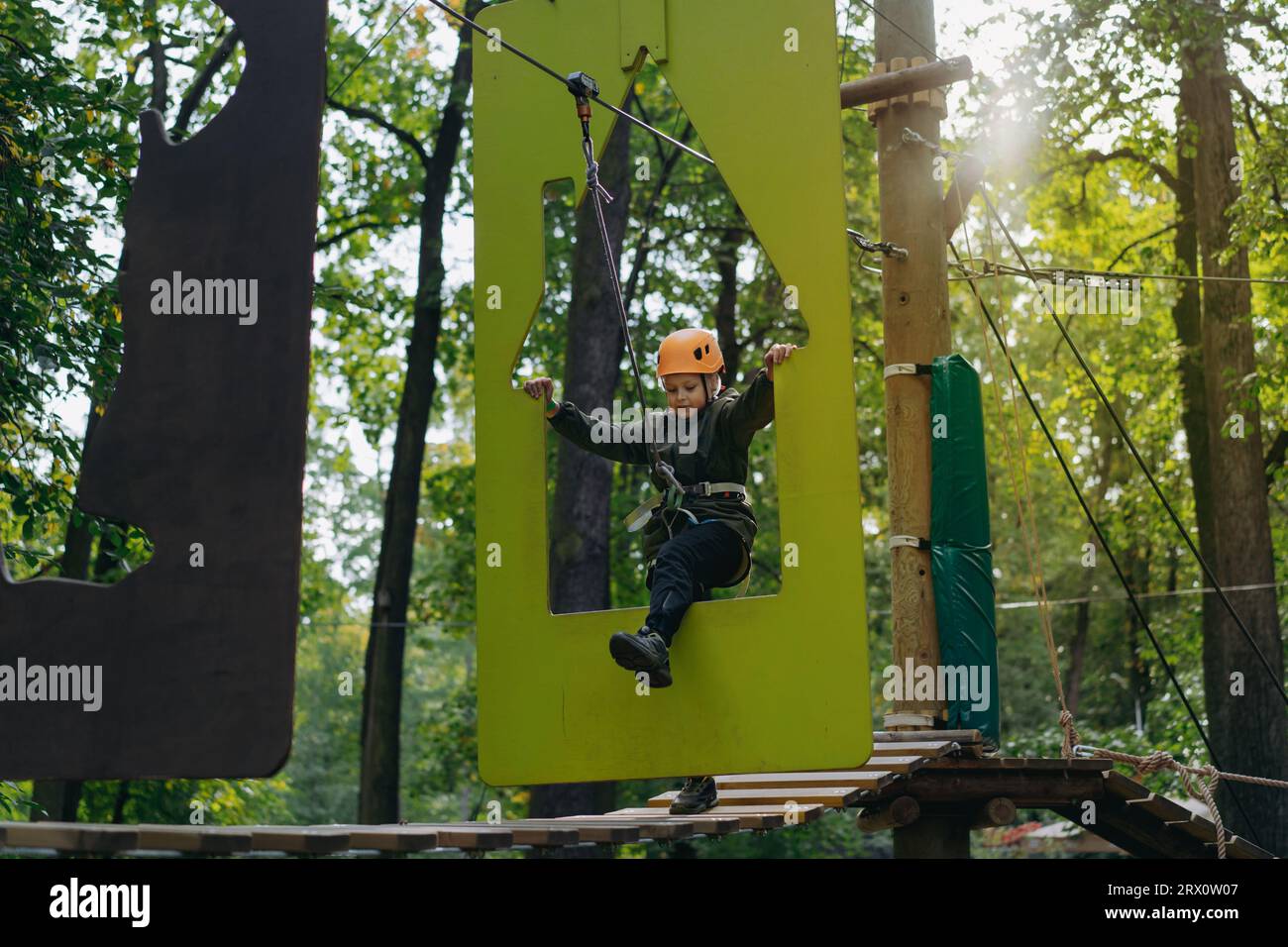 well equipped teenage boy in outdoor passing obstacle course. Active ...
