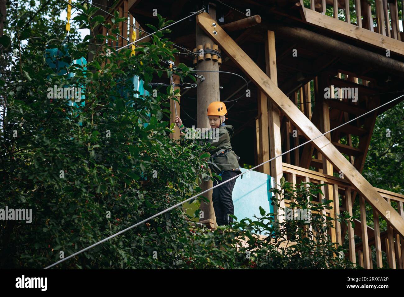 well equipped teenage boy in outdoor passing obstacle course. Active ...