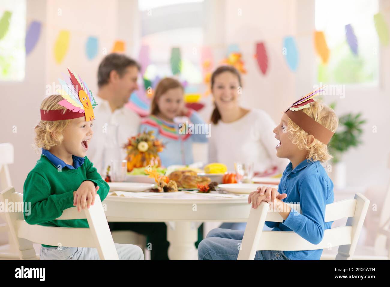 Family with kids eating Thanksgiving dinner. Roasted turkey and pumpkin ...