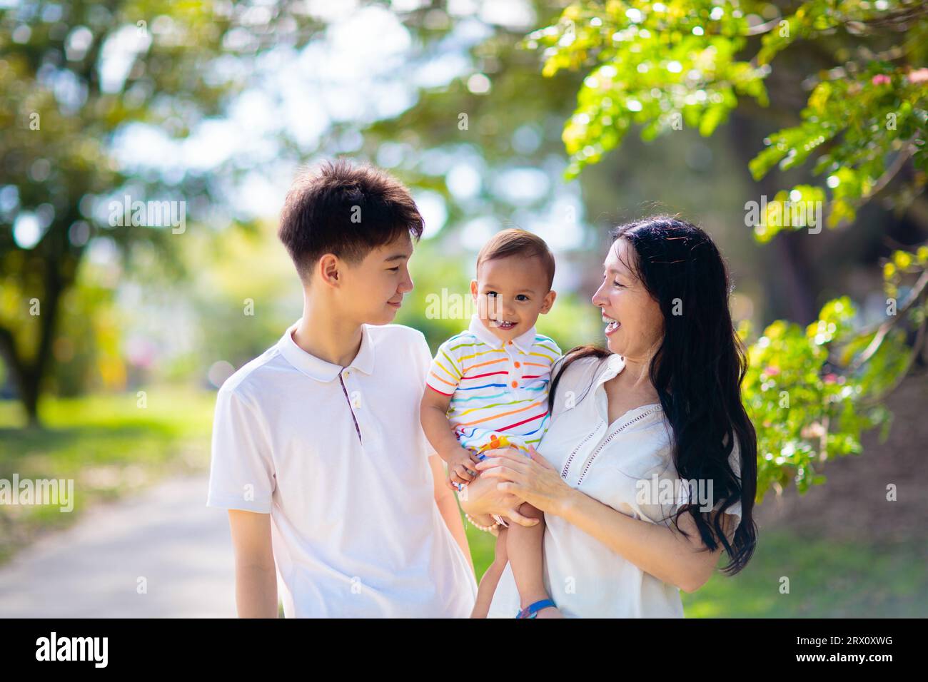 Family walking in summer park. Parents and kids outdoor. Mother, father ...