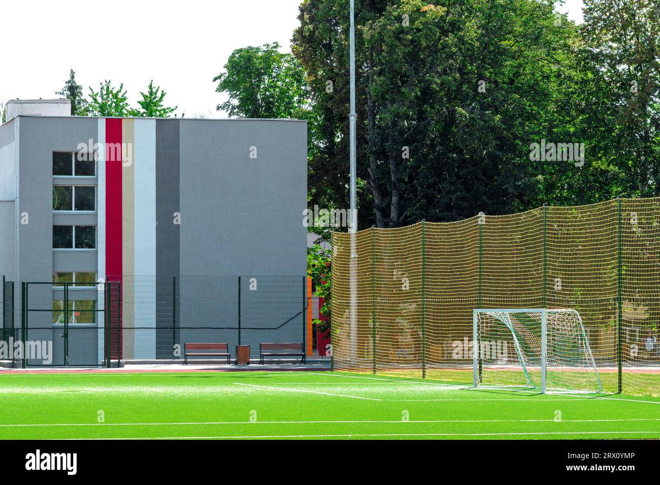 Soccer football field near building. Sport school. sports ground near ...