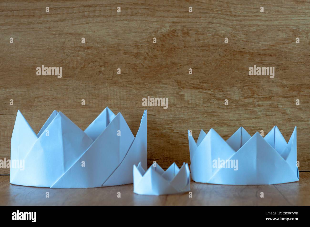 Paper crown. Three paper white crowns. Royal family, royal dynasty ...