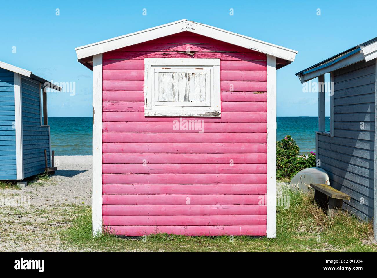 Frontal view of the back of a magenta red wooden bathing hut on the ...