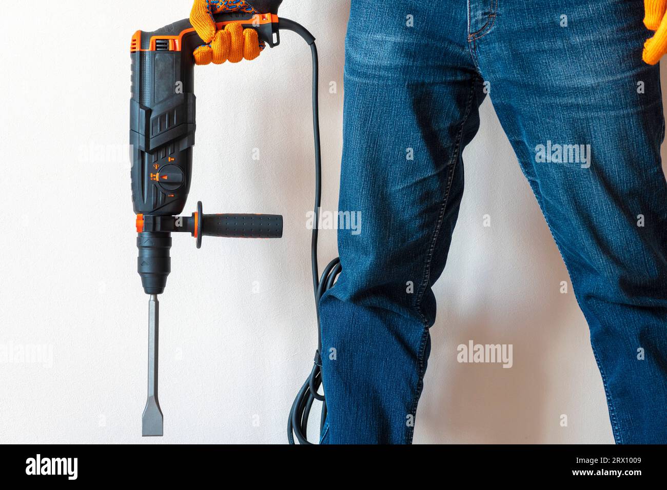 workman with a rotary hammer. worker, professional with hammer drill ...