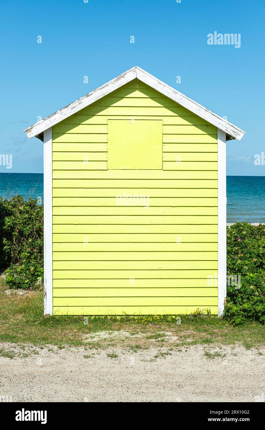 Frontal view of the back of a green wooden bathing hut on the beach of ...