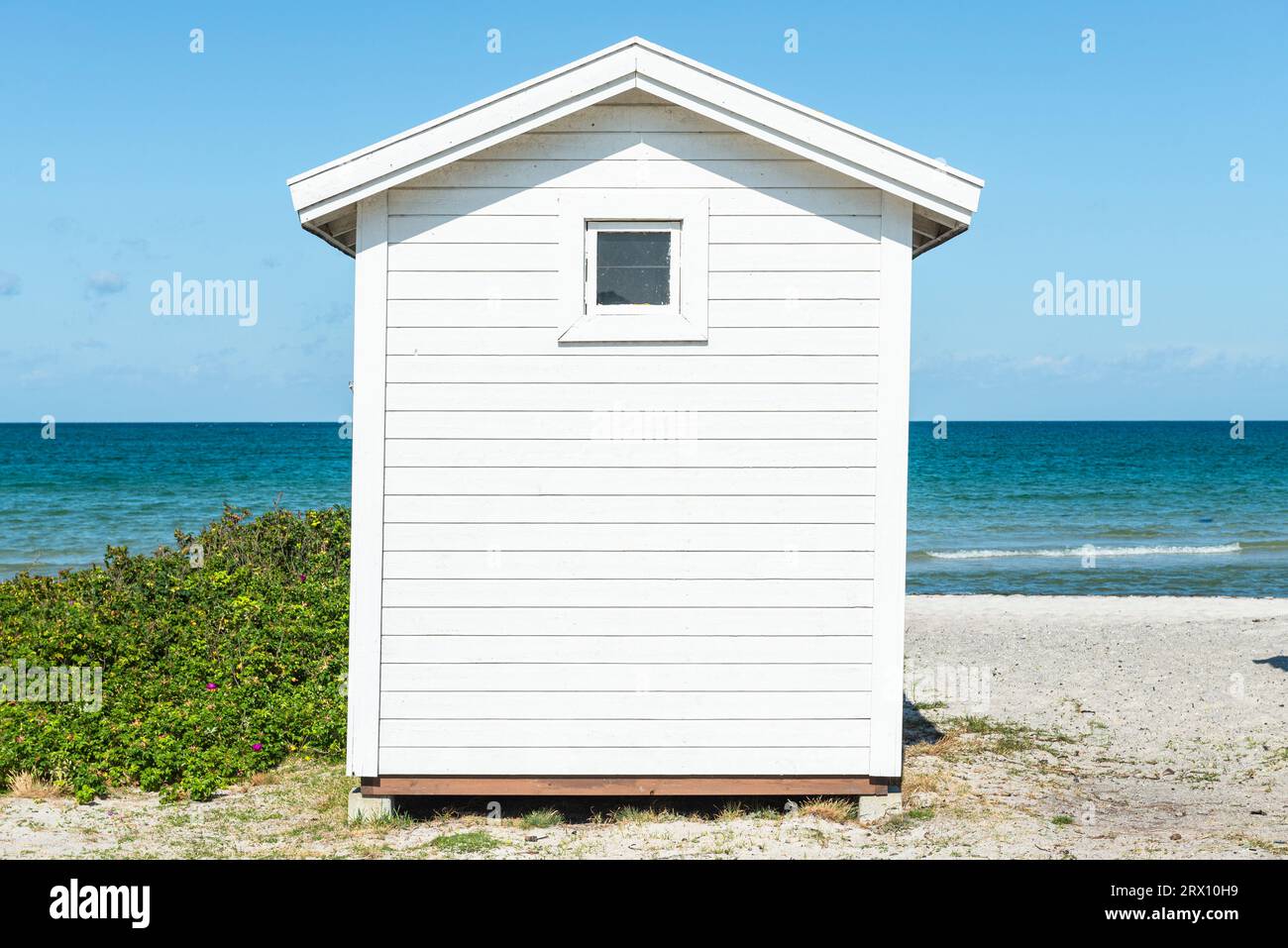 Frontal view of the back of a white wooden bathing hut on the beach of ...