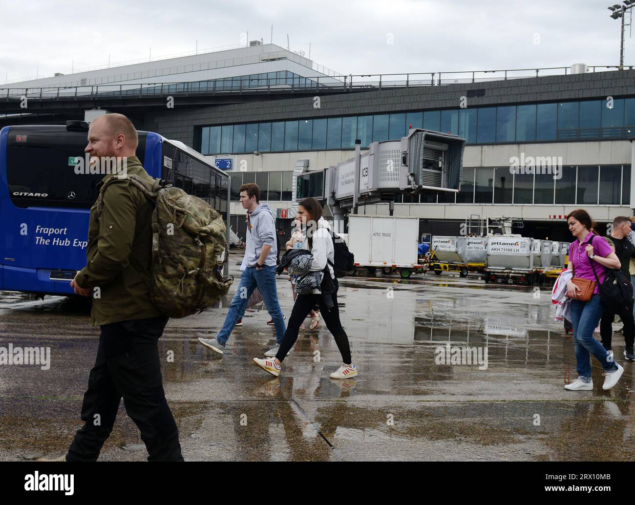 Passengers walking to the bus at Frankfurt Inernational Airport ...