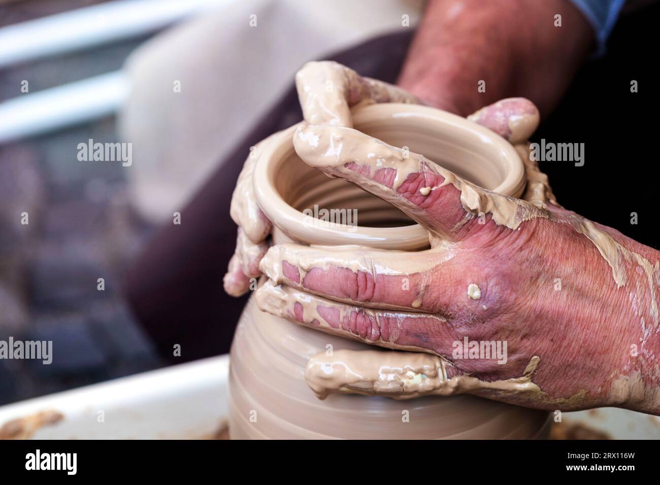 Potter's hands close-up. The man does ceramic ware of clay. national ...