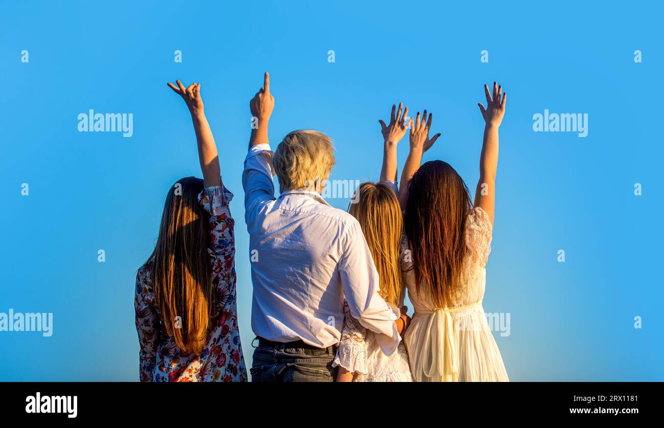 Group male, girls standing together holding hands, raise their hands up ...