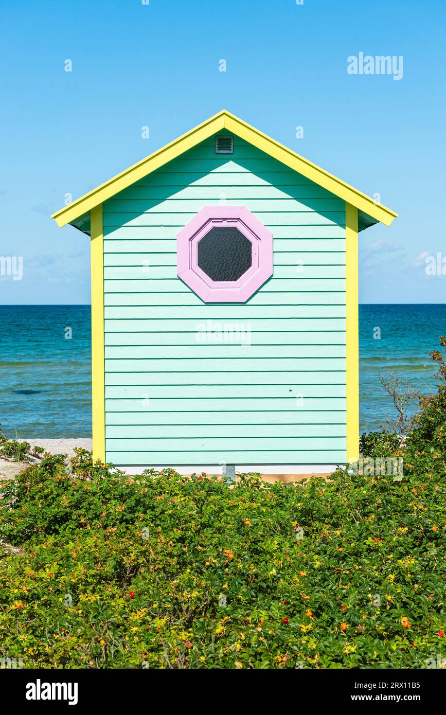 Frontal view of the back of a yellow turqoise wooden bathing hut on the ...