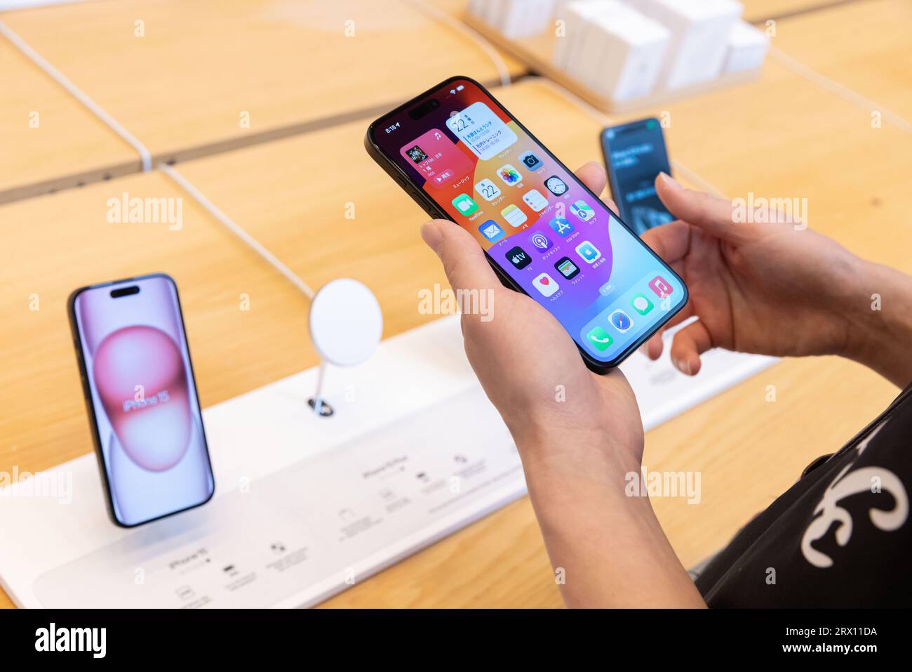 Tokyo, Japan. 22nd Sep, 2023. Customer interacts with the new iPhone 15 ...