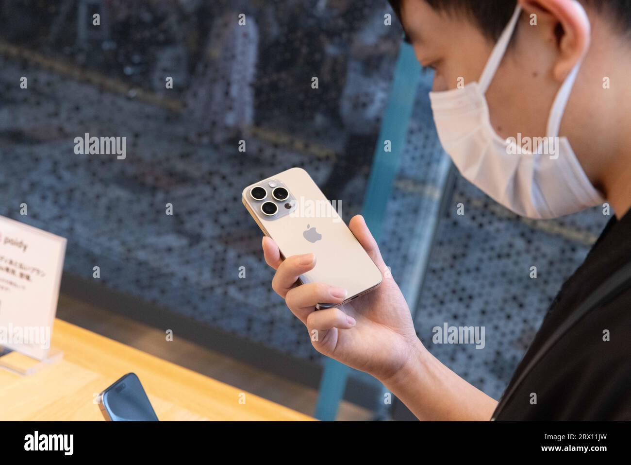 Tokyo, Japan. 22nd Sep, 2023. Customer interacts with the new iPhone 15 ...