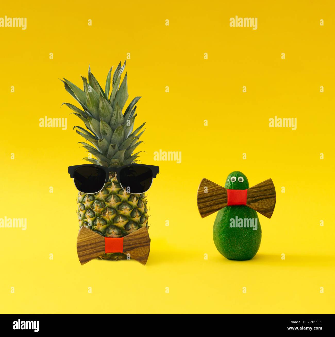 Creative funny composition made of fresh pineapple and avocado with ...