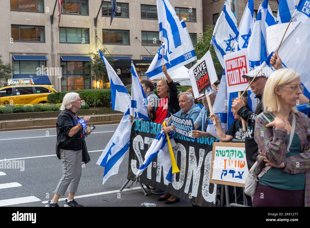 Mostly Israeli Expat holding Israeli flags and signs in support of ...