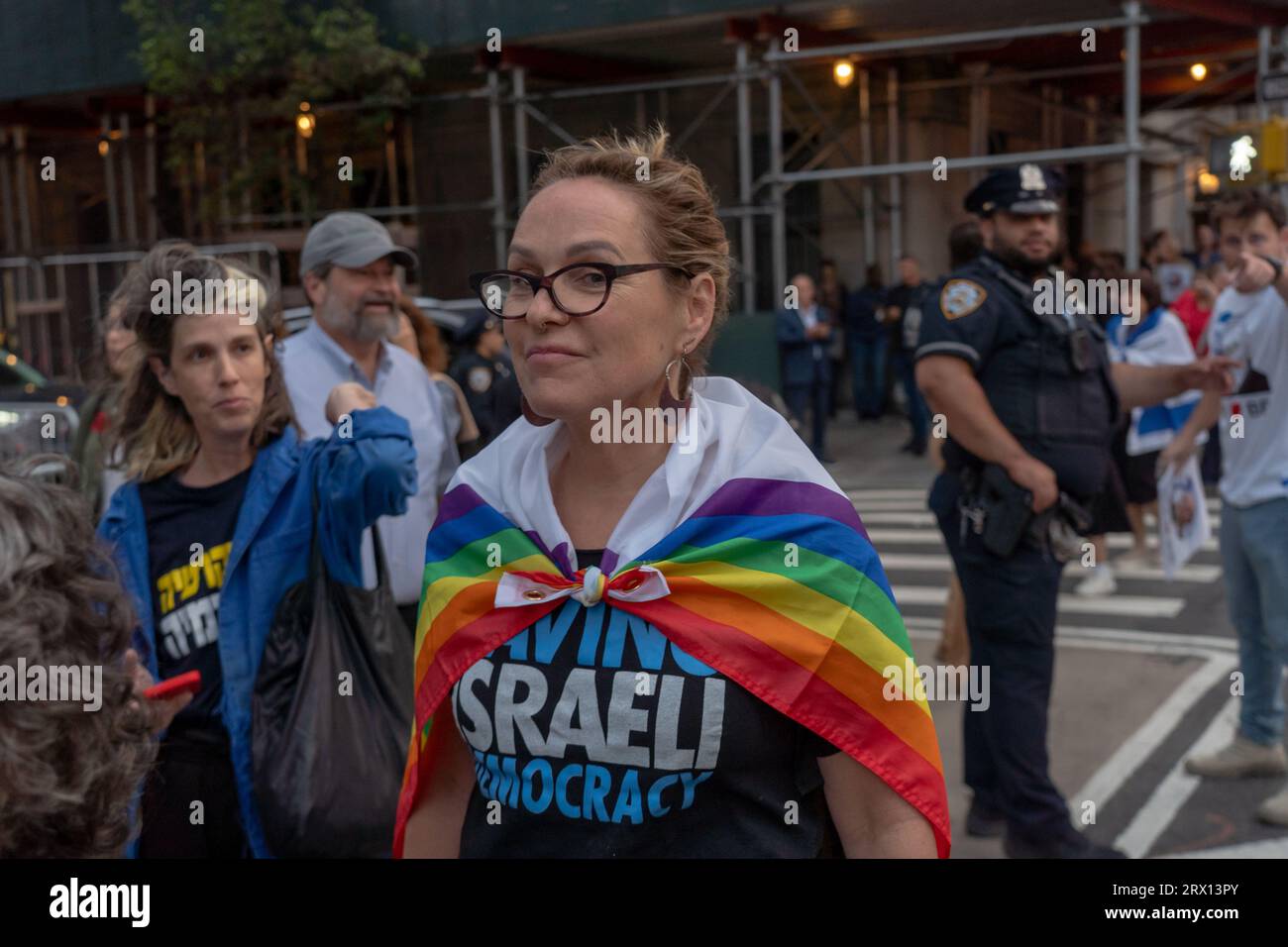 A woman with pride flag arrives at an opposition of the judicial ...