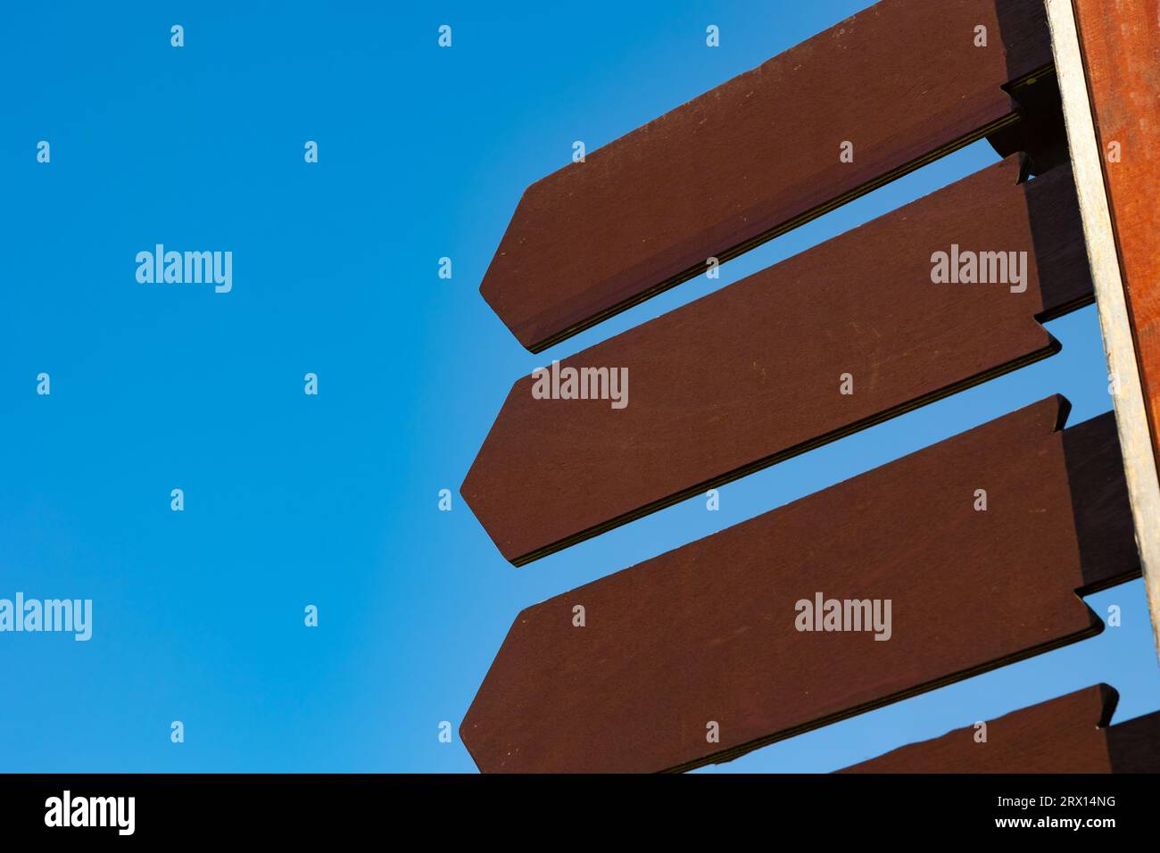 Multiple blank directional signs pointing the left with copy space for ...