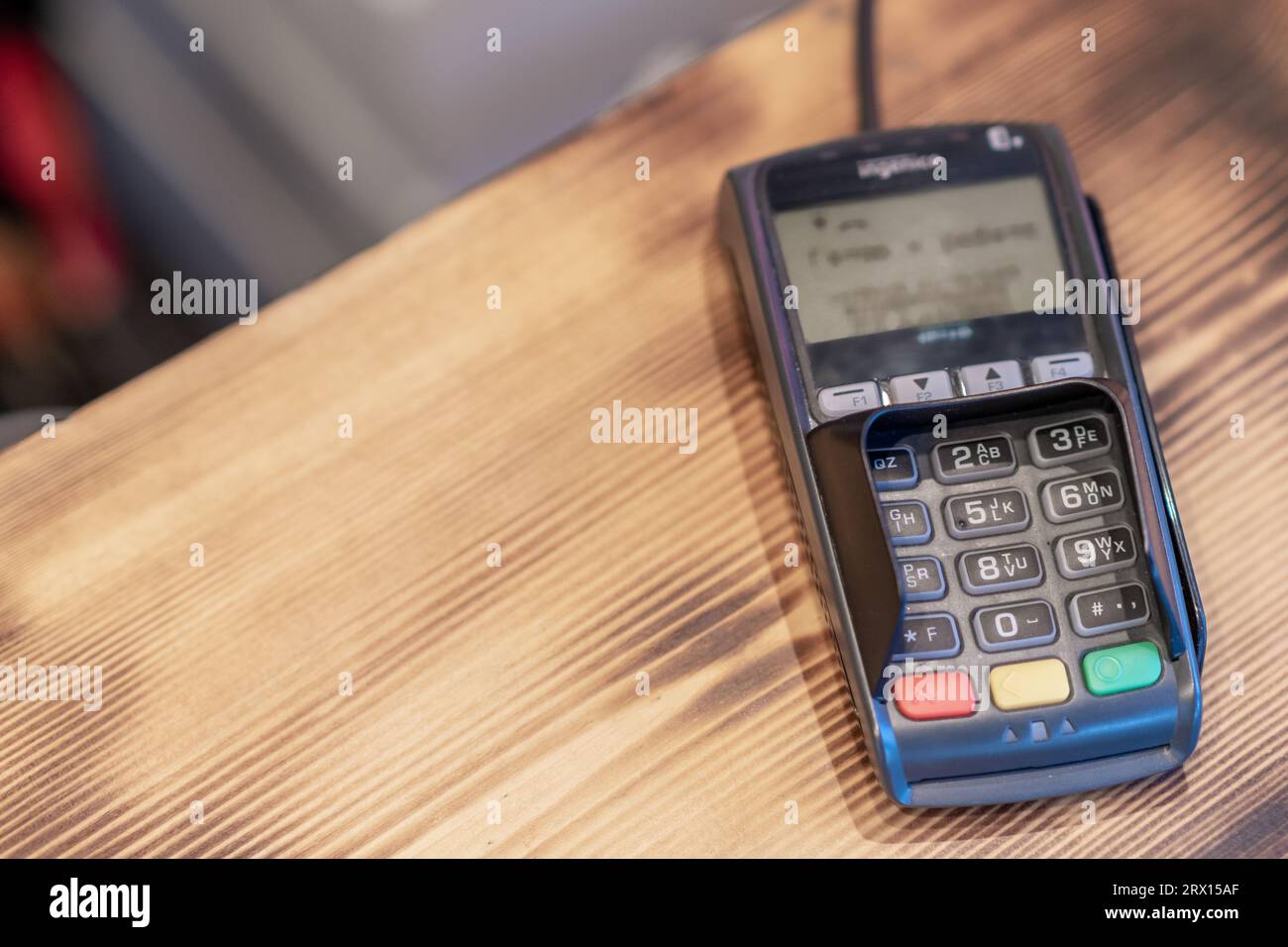 Terminal for cashless payment on a wooden background in a cafe Stock ...