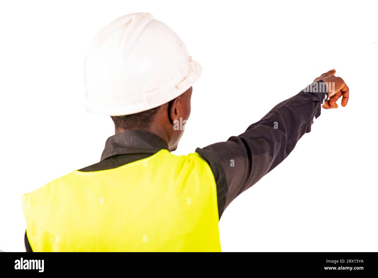 rear view of young man engineer wearing green vest and white safety ...