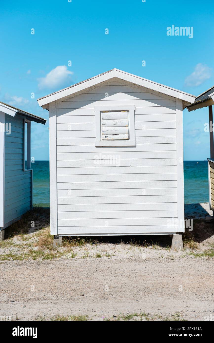 Frontal view of the back of a white wooden bathing hut on the beach of ...