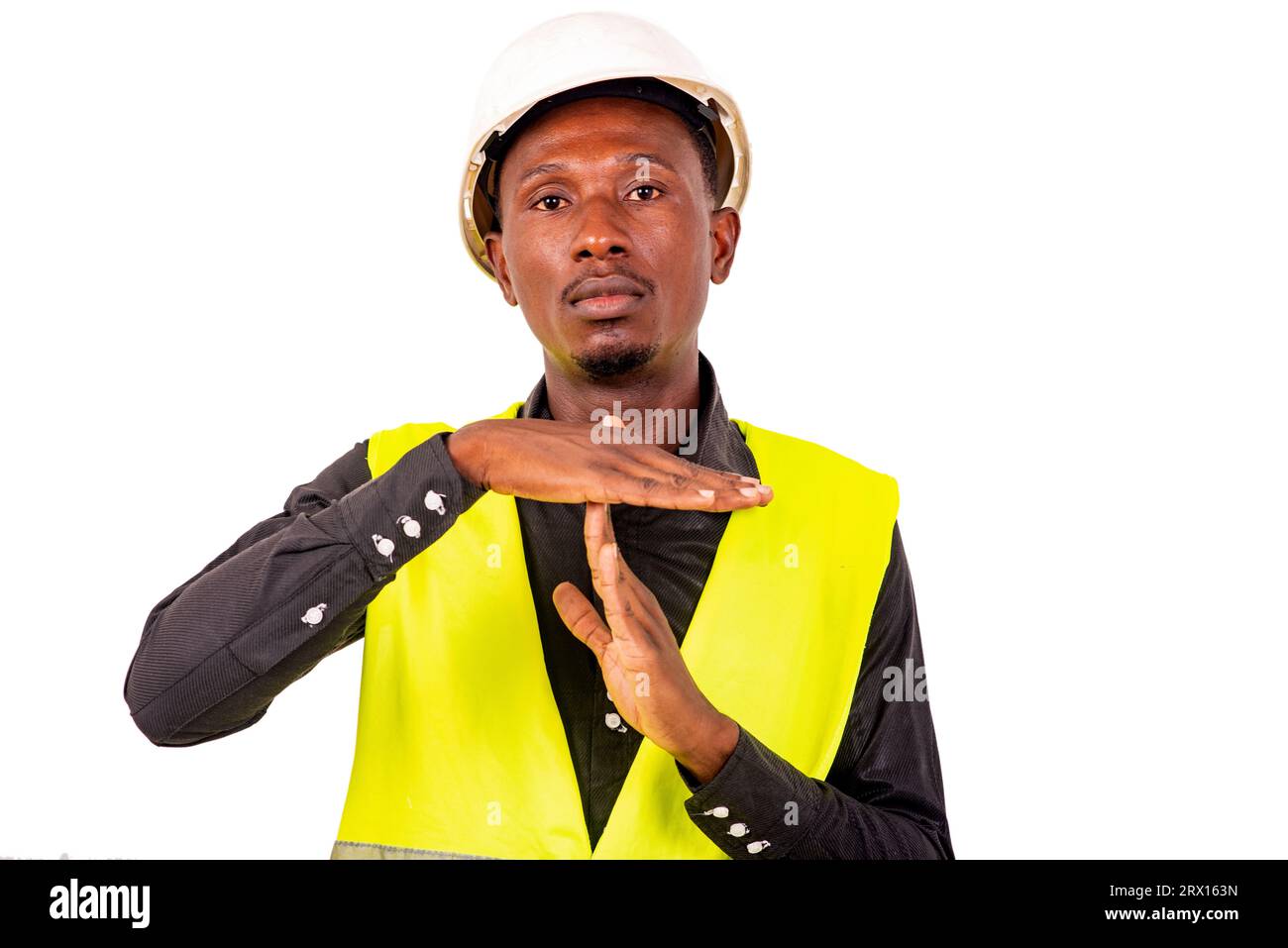 Young tired engineer man wearing green vest and white safety helmet ...