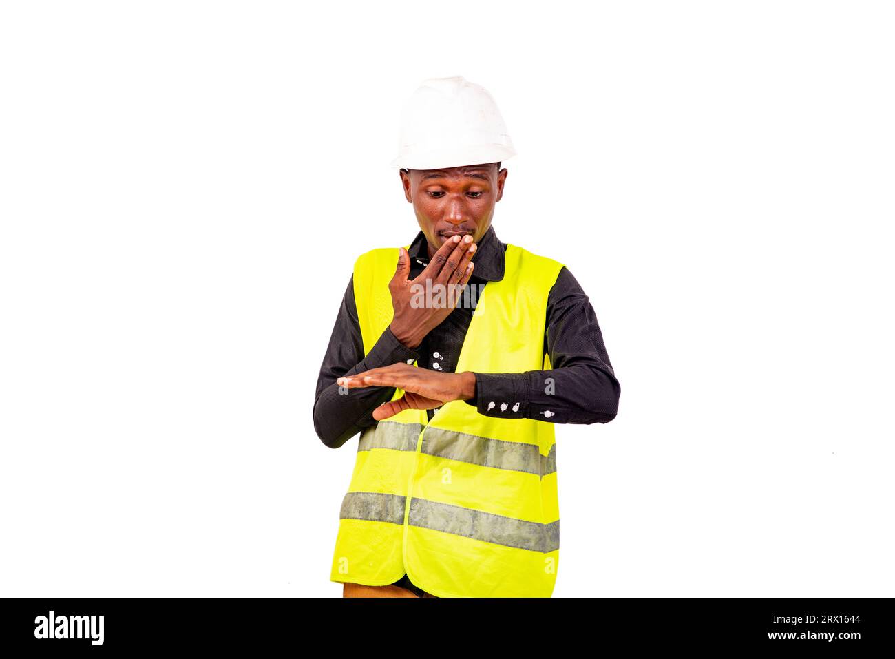 Young astonished engineer man wearing green vest and white safety ...